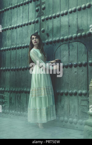 Medieval woman princess in green dress sits astride black steed horse ...