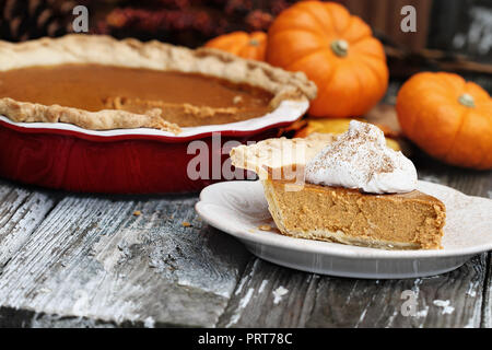 Slice of homemade pumpkin pie over a rustic wooden background. Extreme ...