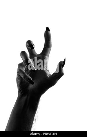 Witch hand with long nail claw is laying on the ground. The hand is ...