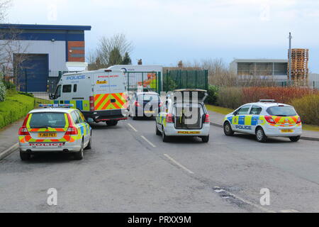 Police vehicles attending a crime scene , where the suspect was thought ...