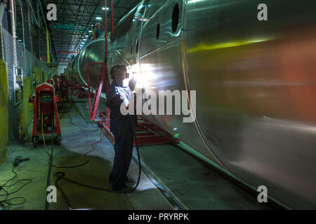 Man welding large steel tank in factory Stock Photo - Alamy