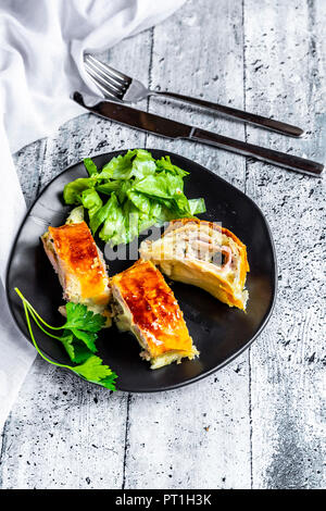 puff pastry roll with cheese on a wooden plate Stock Photo - Alamy