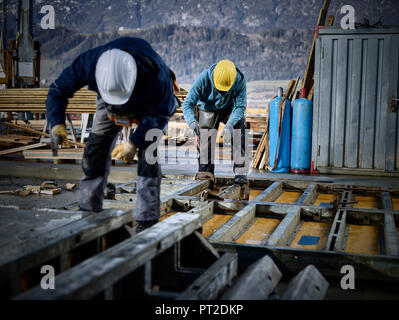 Person works with hammer on wooden to metal bracket among construction ...