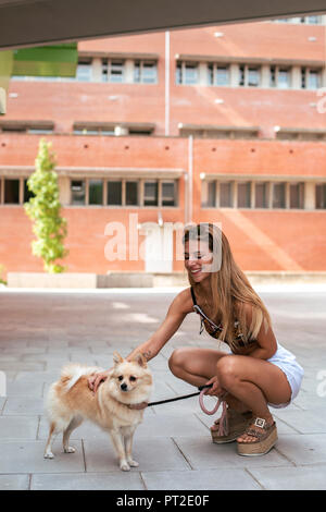 A young woman and her Pomeranian pet dog near Blackfriars Bridge ...