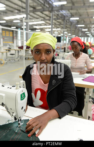 A worker of a textile company produces garment fabric products for export at a workshop in ...