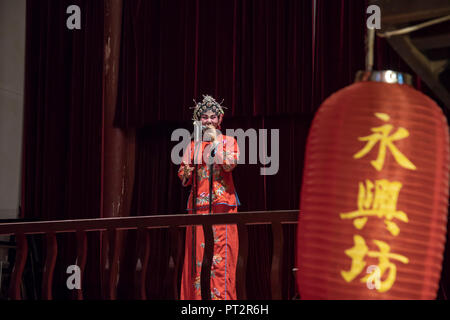 Chinese singer singing onstage in a performance of the Beijing opera in ...