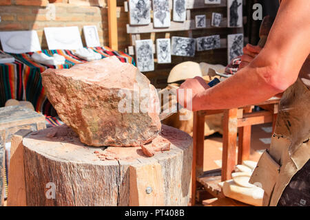 Artisan stonecutter with ancient tools of an ancient artisan ...
