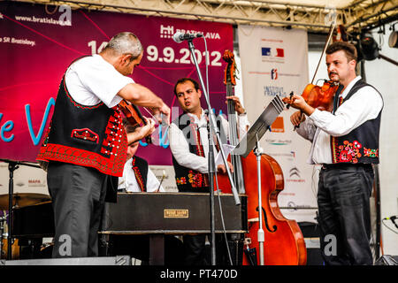 Slovak folk musician in traditional costume singing a pastoral song. He ...