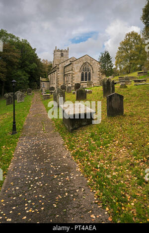 View along churchyard path, past headstones, to east window of historic ...