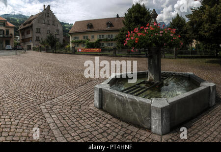 Public fountain and geraniums in Flums Swiss Alps Stock Photo - Alamy