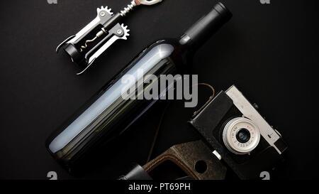 A photo of a vintage corkscrew, a cork, and a glass of wine, shot on a ...