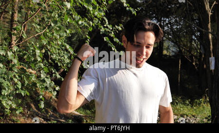 Young man exulting happy in nature, standing Stock Photo - Alamy