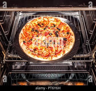 Delicious appetizing pizza with tomato sauce, mozzarella and tomatoes ...