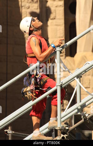 a workman working at height wearing an high visibility vest without any ...