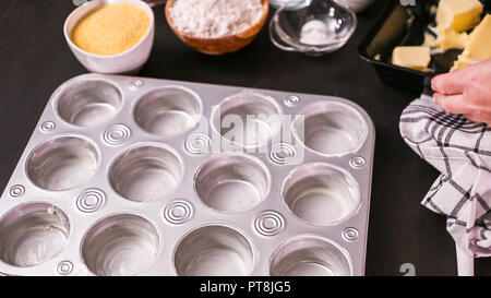Step by step. Buttering metal cupcake pan to bake cornbread muffins ...
