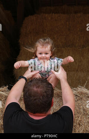 Child jumping into her father's arms Stock Photo - Alamy
