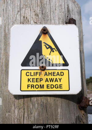Cliff danger warning sign - with man falling over cliff, cliff edge ...