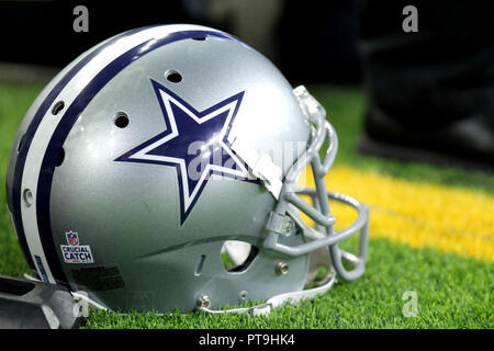 A Dallas Cowboys helmet rests on a Gatorade cooler during an NFL ...