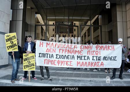 Athens, Greece. 8th October, 2018. A woman holds placard outside of the ...