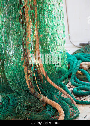 fishing boat commercial trawler with green nets out of water and up on ...