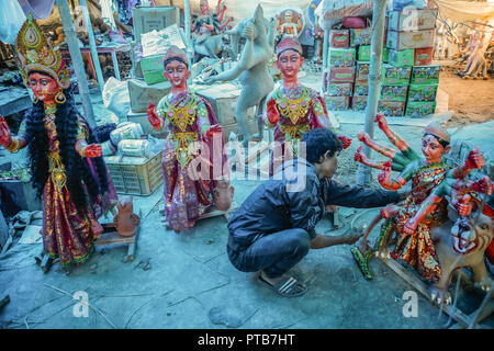 An artist decorates an idol of Hindu Goddess Durga, the matriarch of ...