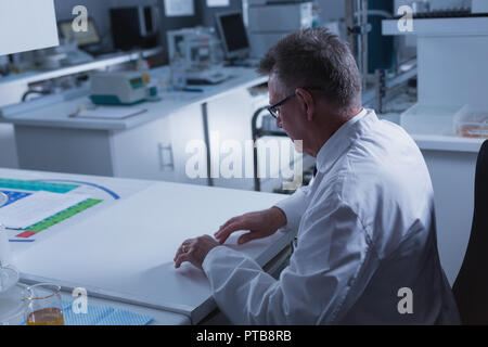 Male scientist using unseen new technology at desk Stock Photo - Alamy