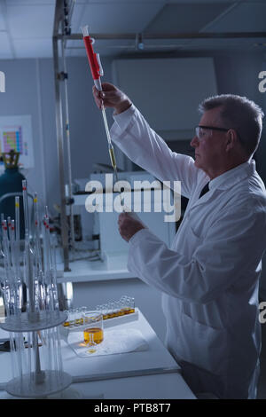 Male scientist experimenting in laboratory Stock Photo - Alamy