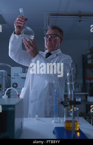 Focused scientist examining a test tube in a laboratory setting Stock ...