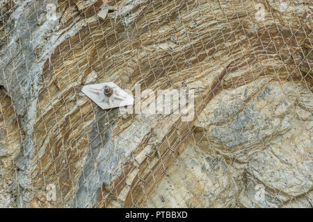 Chain link rockfall protection mesh and anchor point Stock Photo - Alamy