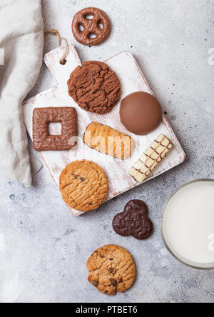 Oat and chocolate cookies selection on wooden board on stone kitchen ...