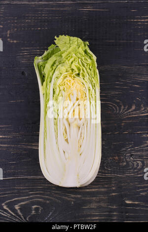 Chinese cabbage cut in half isolated on a black background Stock Photo ...