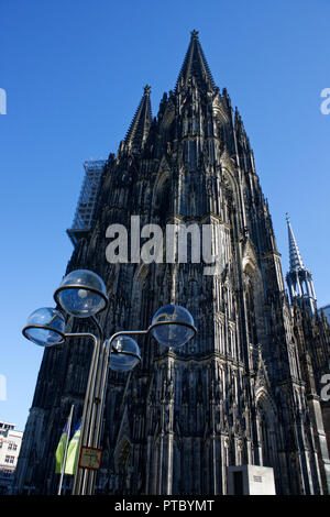 Koln Cologne Cathedral twin spires silhouetted floodlit against evening ...