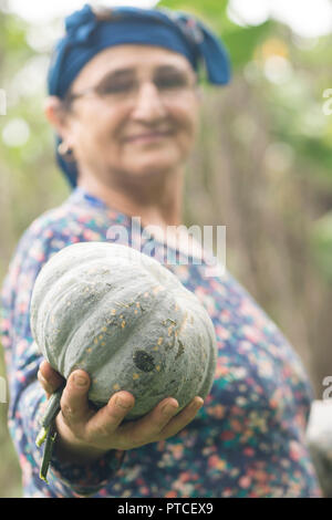 Senior holding a halloween pumpkin Stock Photo - Alamy