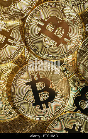 Many Bitcoin coins on gold background Stock Photo - Alamy