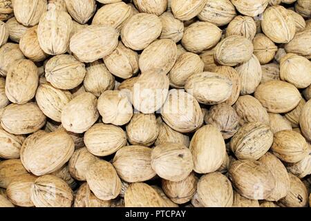 Crude walnut with nutshell for background of texture Stock Photo - Alamy