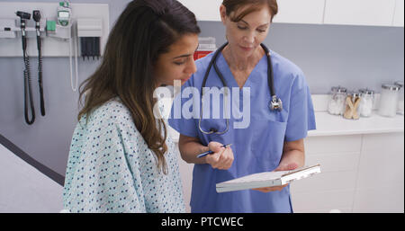 A hospital nurse checking patient notes on the ward trolley Stock Photo ...