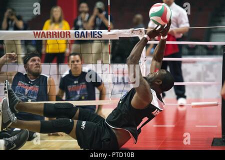 Army veteran Staff Sgt. Charles Hightower sets a ball during the ...