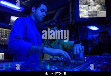 Sailors work the ouija board in flight deck control during nighttime ...