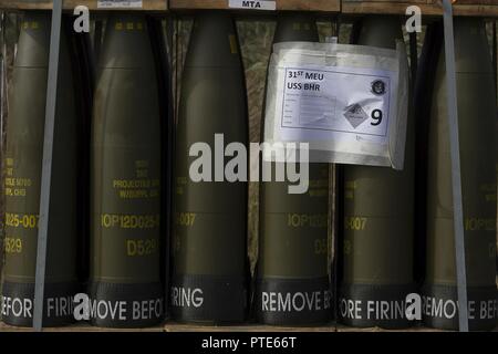 A pallet of 155 mm artillery shells and other munitions sit staged on ...