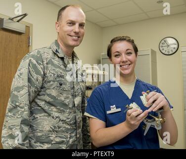 A U.S. Army dental technician works on a villager's teeth during a ...