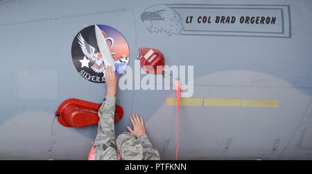 An Airman from the 550th Fighter Squadron reveals the new squadron patch during an activation ...