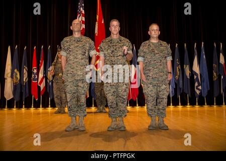 Sgt. Maj. Justin LeHew, outgoing regimental sergeant major, left, hands ...