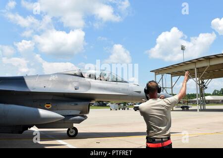 A U.S. Air Force marshalling Airman turns his back to avoid the ...