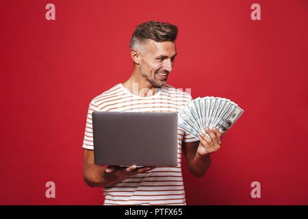 Handsome guy with stubble in striped t-shirt laughing on camera ...