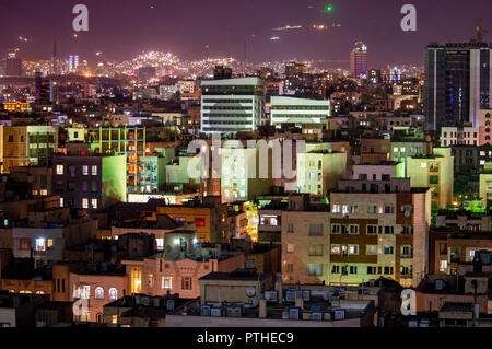 Skyline of Tehran, Iran with high rise buildings against snow capped ...