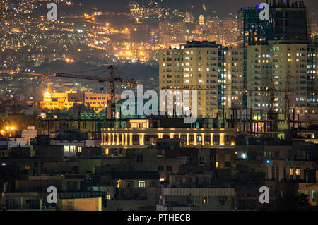 Skyline of Tehran, Iran with high rise buildings against snow capped ...
