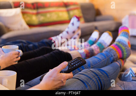 Family with colorful socks relaxing, watching TV in living room Stock ...