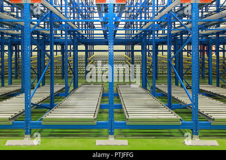 Dynamic storage with conveyer rollers in new warehouse Stock Photo - Alamy