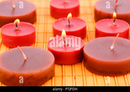 Many candles on bamboo mat background Stock Photo - Alamy