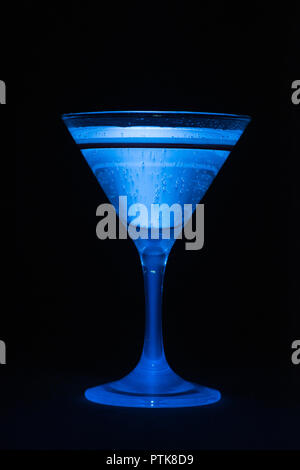 Glowing blue tonic water, quinine, as used in gin and tonic emmits ...